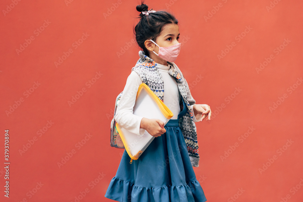 Beautiful kid in protective face mask going back to the school during ...