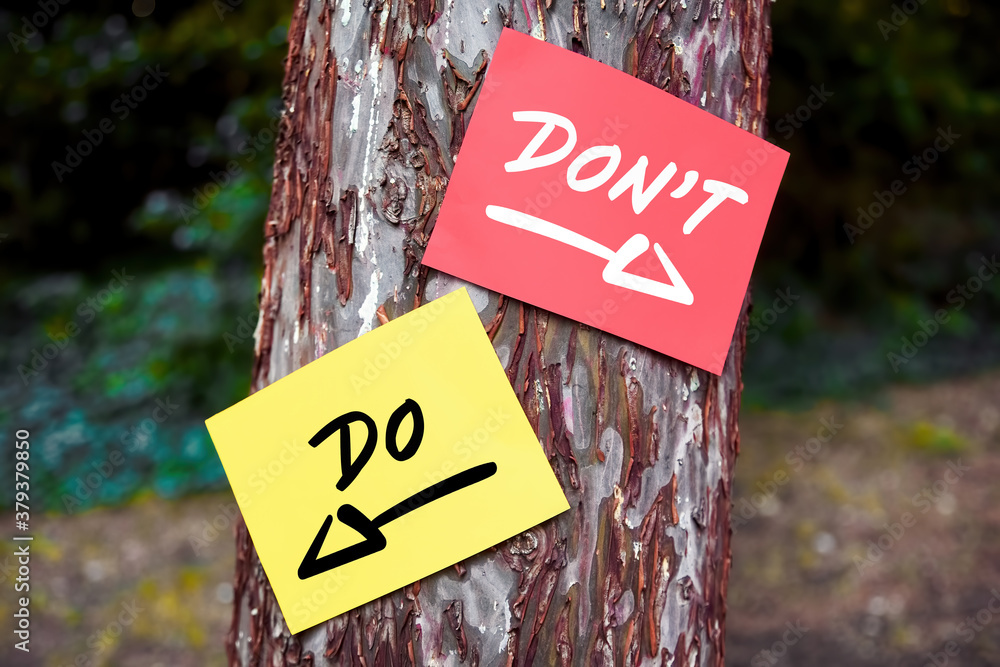 Do and don't words written on papers on a tree with arrow signs ...