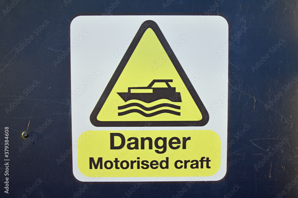 Isolated warning sign for danger motorised craft in yellow triangle ...