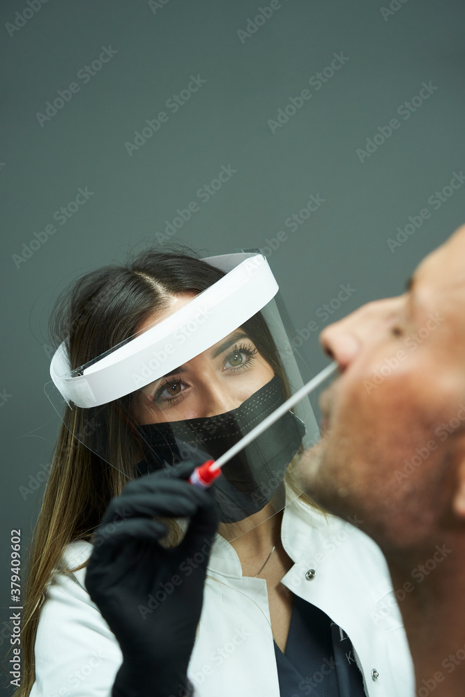 Virus Swab Test. Female doctor doing a nasopharyngeal swab test to a ...