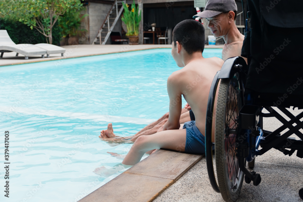 Strong arm muscles of Asian special child on wheelchair and father with ...