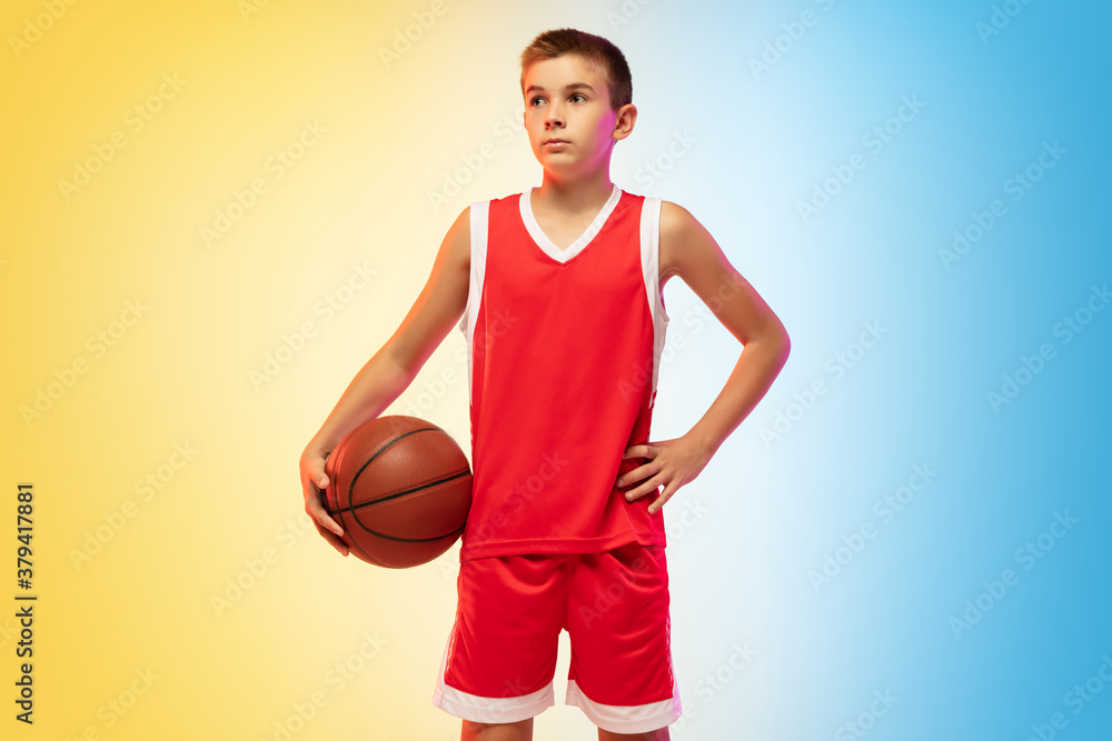 Full length portrait of young basketball player in uniform on gradient ...
