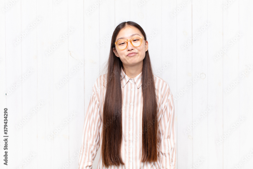 asian young woman looking goofy and funny with a silly cross-eyed ...