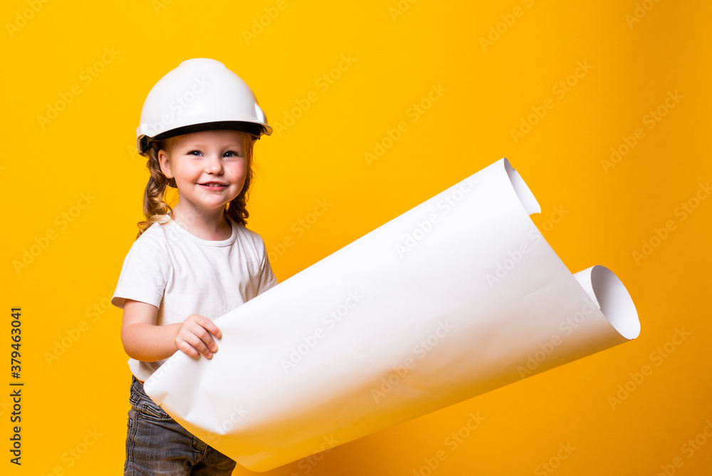 Little girl architect in the construction helmet with a poster isolated ...