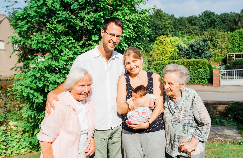 Happy multi-generational family with newborn baby outdoors Stock Photo ...
