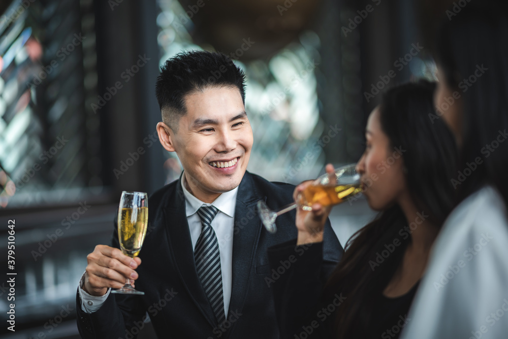 Cheers! Group of people cheering with champagne flutes in pub interior ...