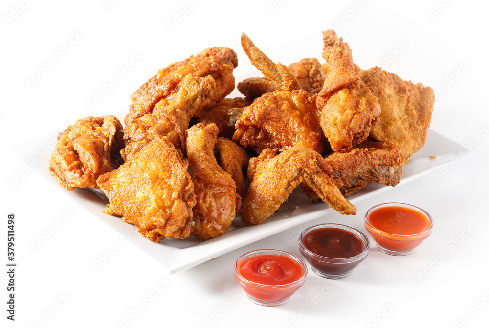 Platter of family sized fried chicken with three sauces on white ...