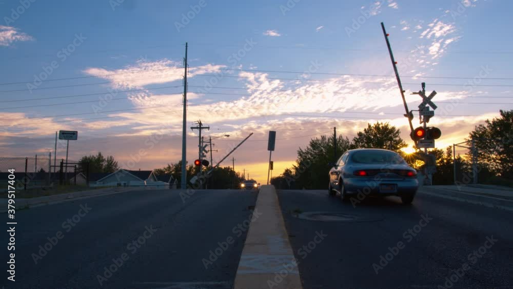 A railway stop after a train has passed the lights flash and the gate ...