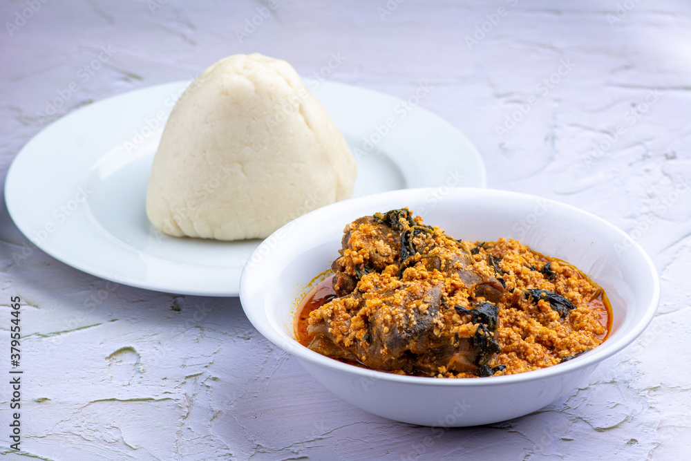 Egusi soup with fufu or pounded yam Photos | Adobe Stock