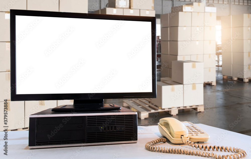 Desktop computer blank screen and stack of cardboard boxes in ...