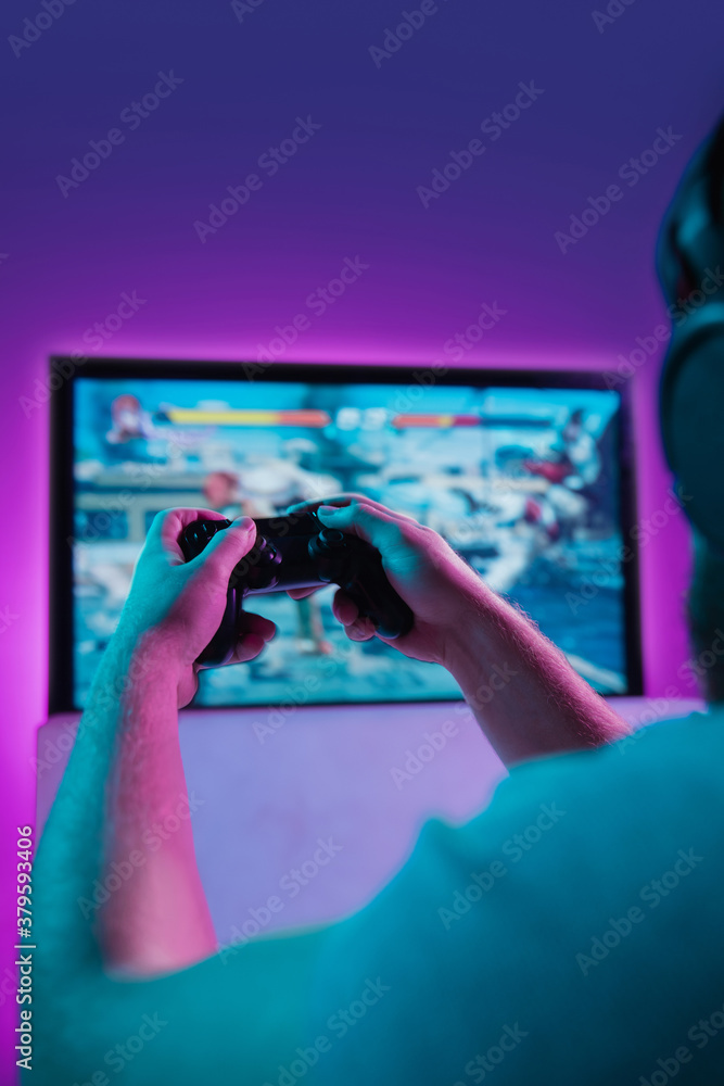 Back view close up of professional gamer playing online video game with ...