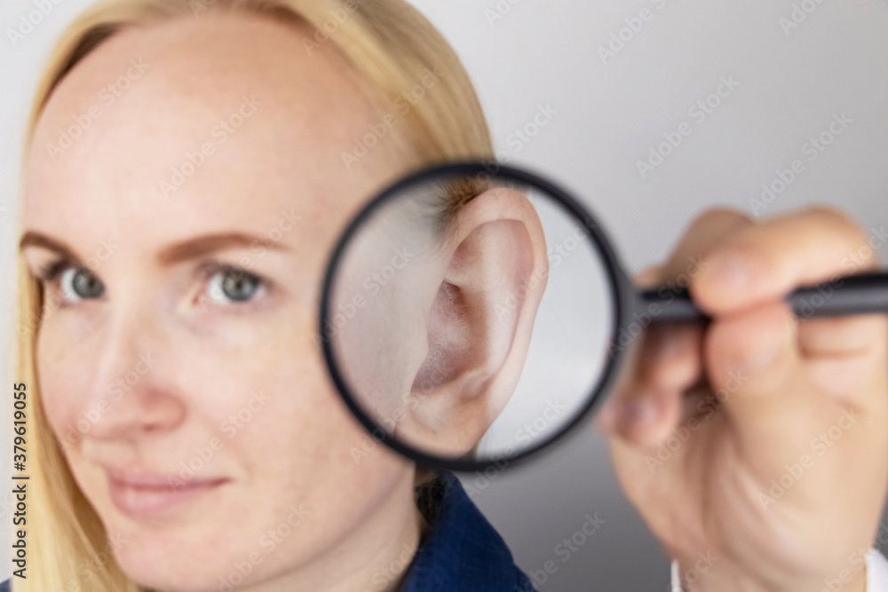 Darwin's tubercle on the ear. The girl at the reception at the plastic ...