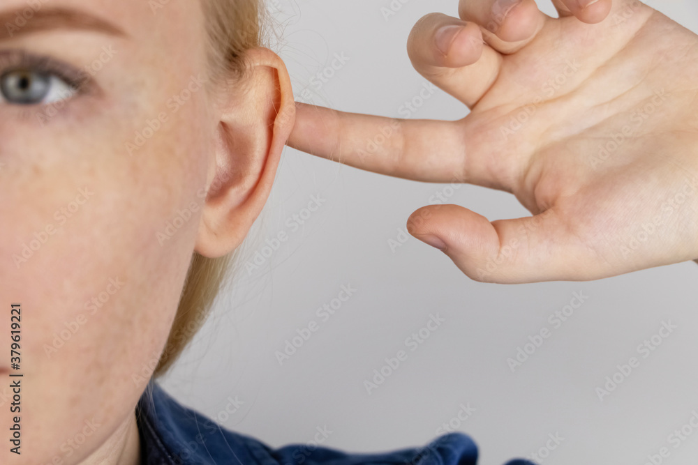 Darwin's tubercle on the ear. The girl at the reception at the plastic ...