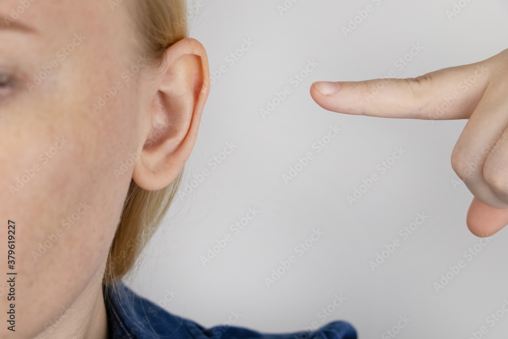 Darwin's tubercle on the ear. The girl at the reception at the plastic ...