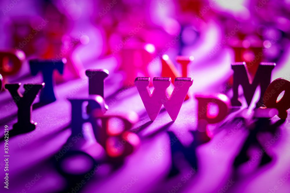 English alphabet letters close up. All letters except w are blurred ...