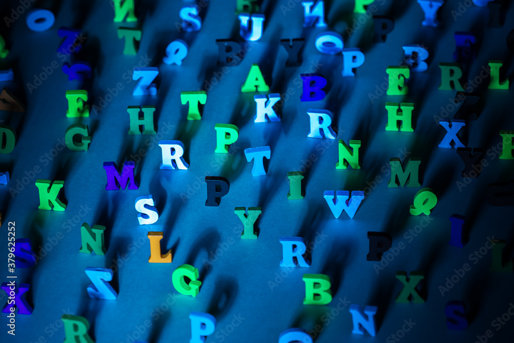 Multicolored letters of the alphabet. Chaotic English letters cast a ...