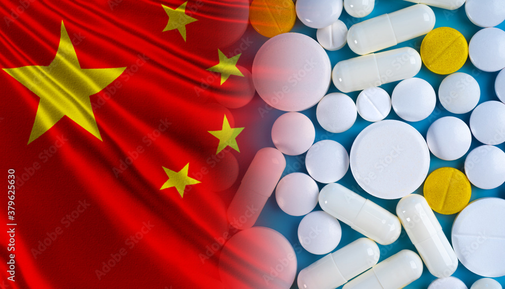 Pharmacological industry in China. Various tablets next to flag of ...