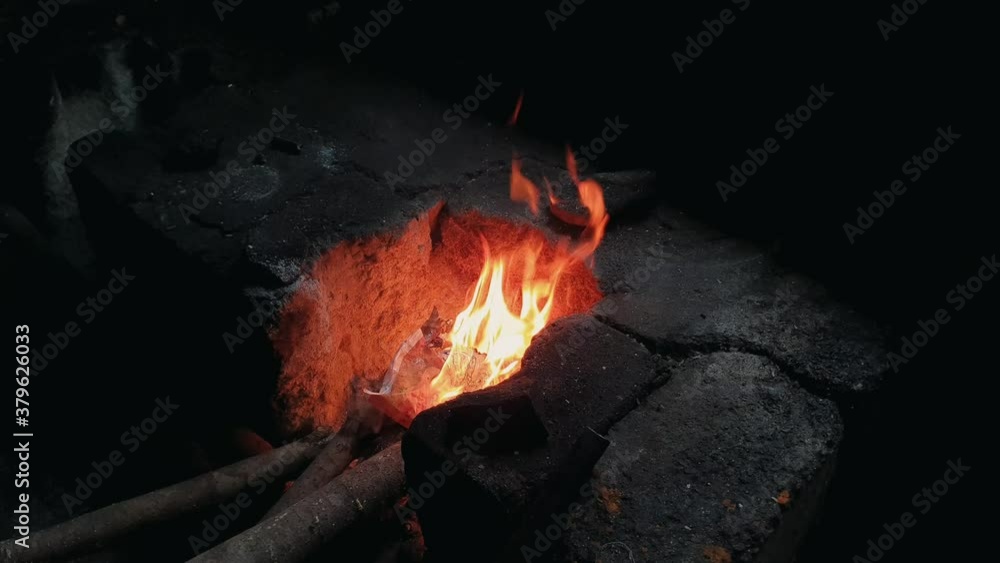 Traditional way of making food on open fire in old Indian kitchen in a ...