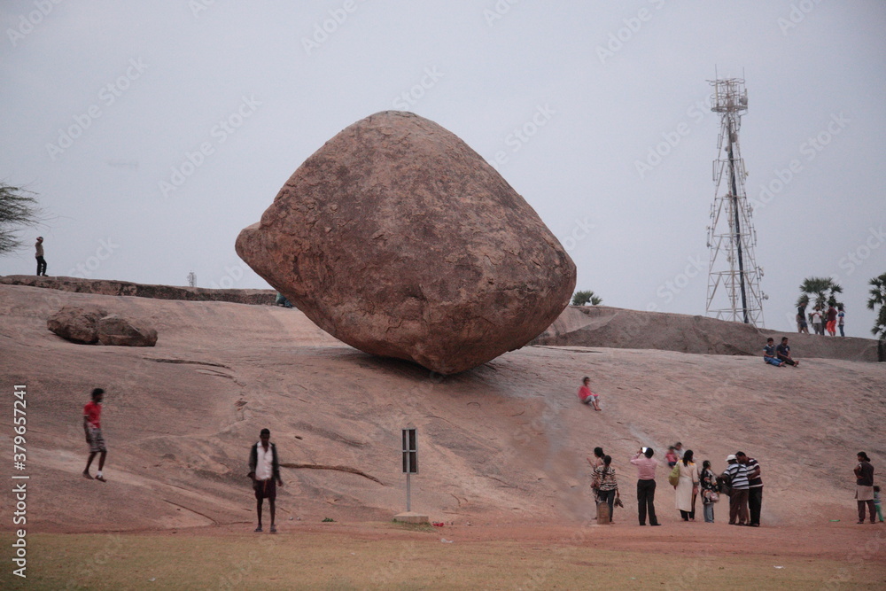 Tourists visiting a gigantic balancing granite boulder Krishna's ...