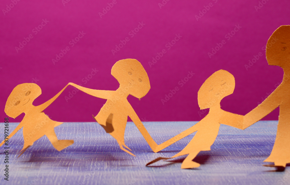 paper people holding hands together Stock Photo | Adobe Stock