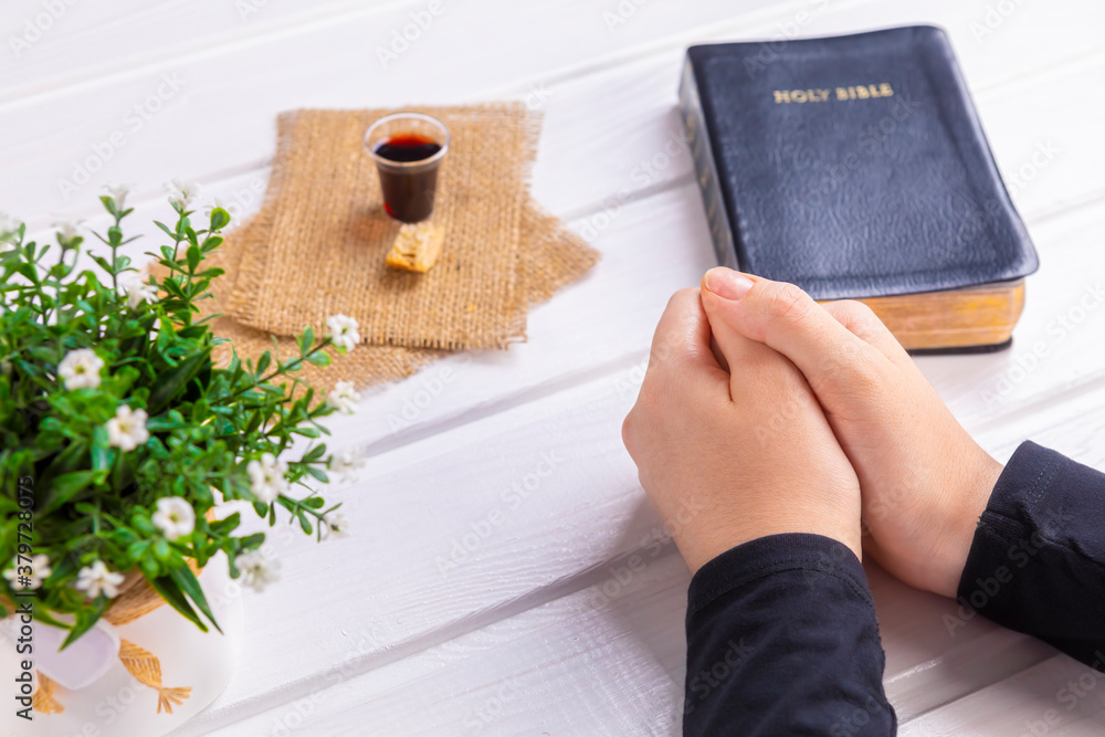 Young woman praying and Taking communion - the wine and the bread ...