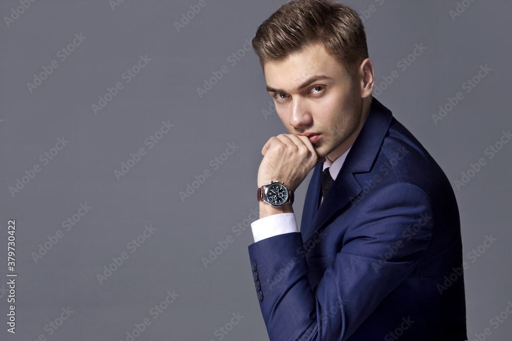 portrait of a man sitting with a suit with a watch, studio Stock Photo ...