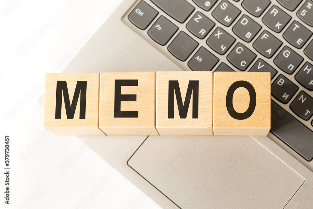 Word memo. Wooden cubes with letters isolated on a laptop keyboard ...