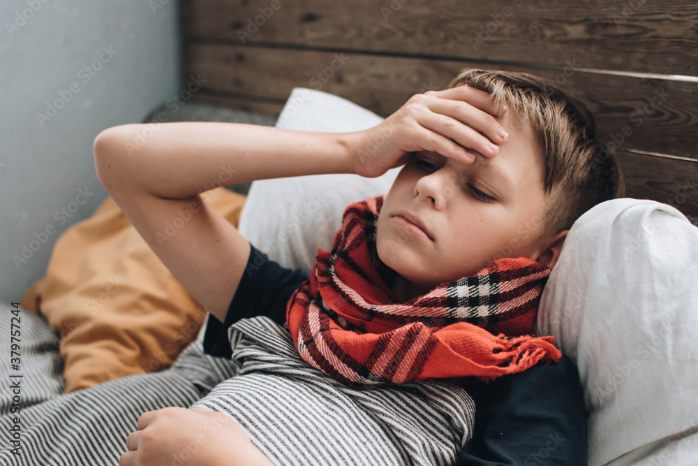 Zdjęcie Stock: Sick teenage boy with flu is sneezing and coughing on ...
