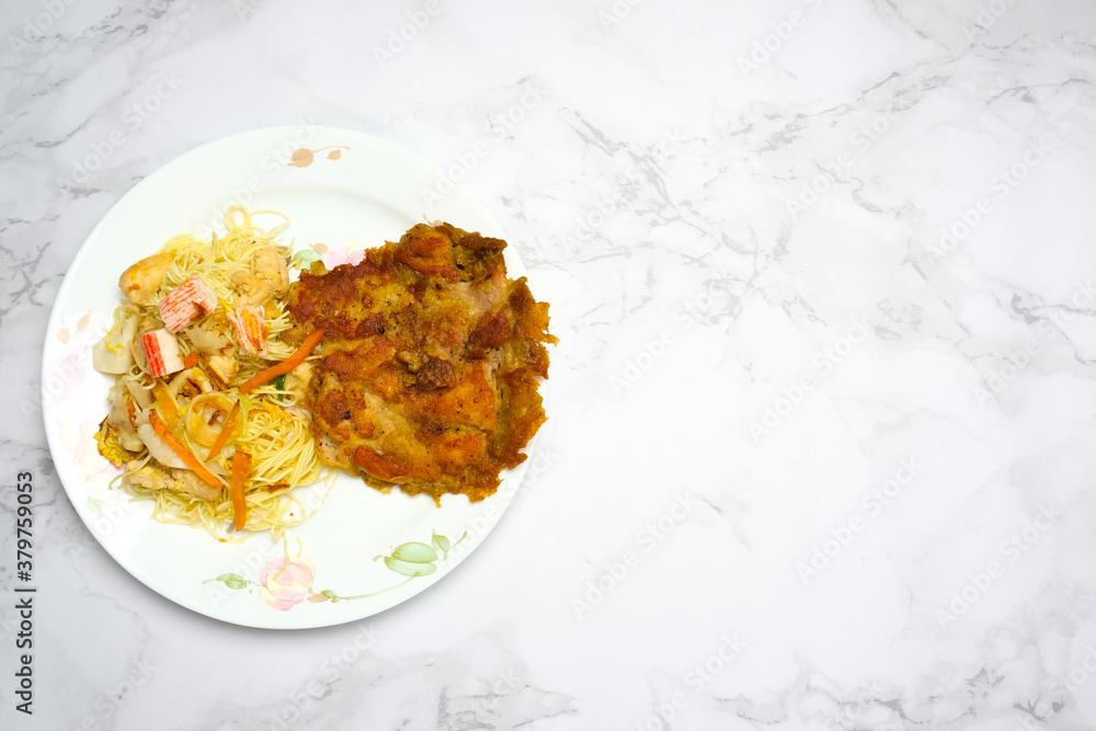 Flatlay picture of "mee raja" with chicken chop on copy space marble ...