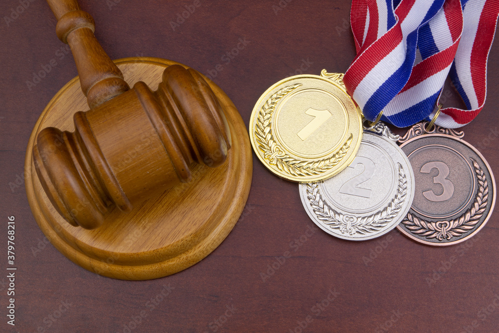 Gold medal, silver medal, bronze medal and wooden judge gavel ...