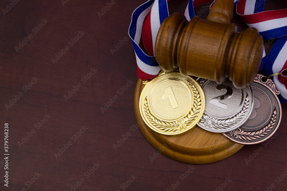 Gold medal, silver medal, bronze medal and wooden judge gavel with copy ...