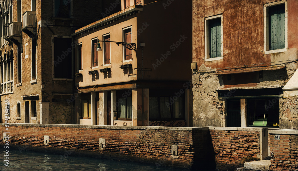 Old rustic mediterranean houses and shops with canal at old quarter ...