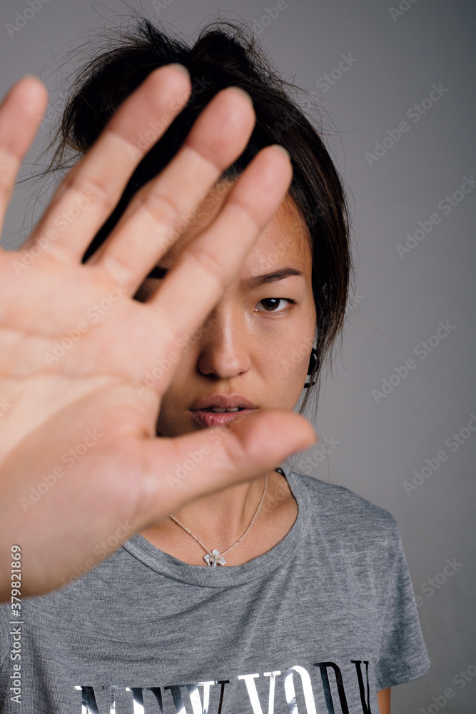 Young Asian girl hiding face from camera Stock Photo | Adobe Stock