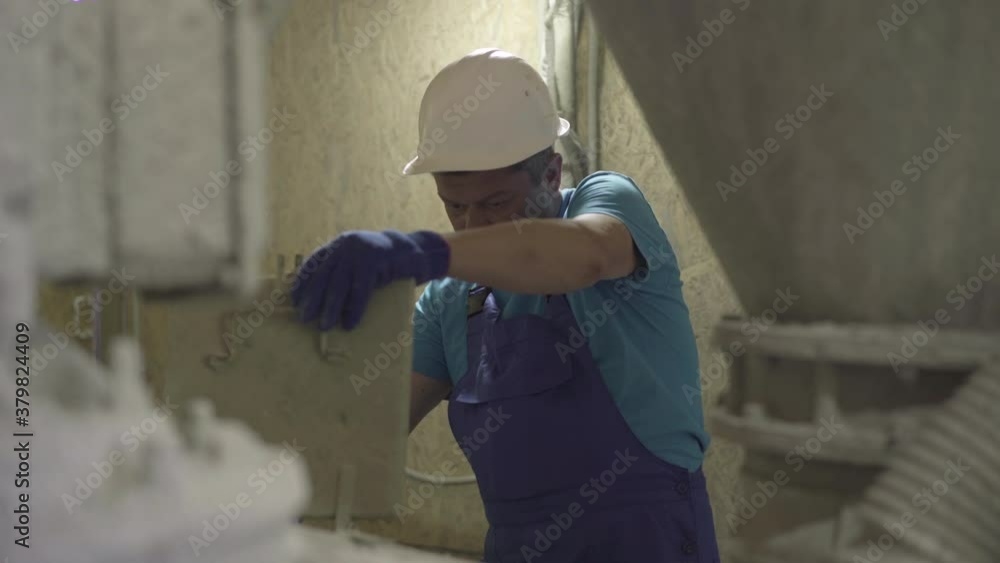 Middle shot of serious Caucasian male worker controlling equipment on ...