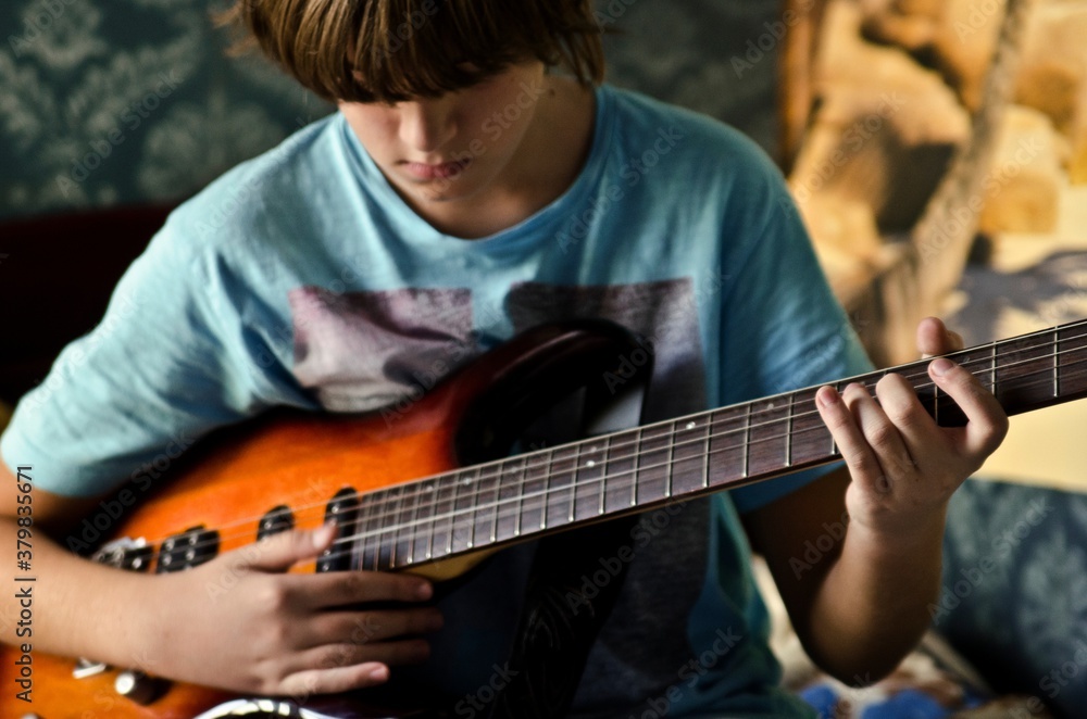 Boy is playing electric guitar in retro room of his parents Stock Photo ...
