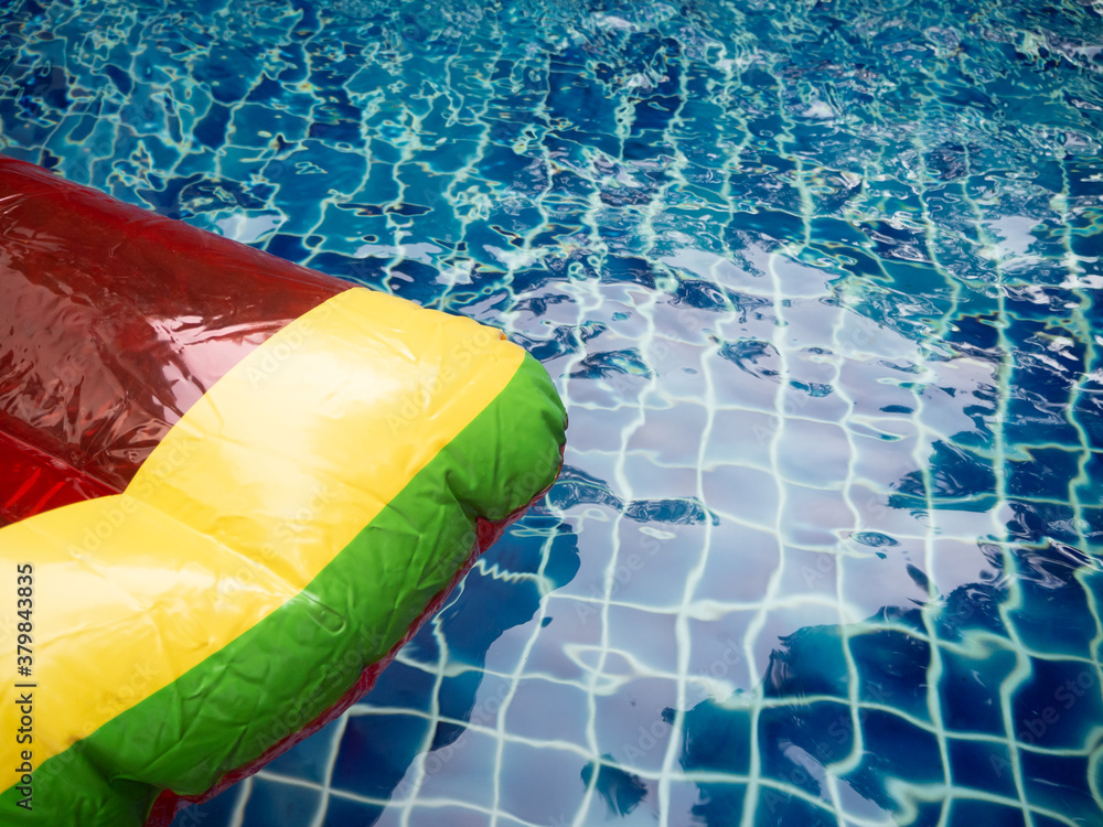 funny summer background concept. colorful pool float in swimming pool ...