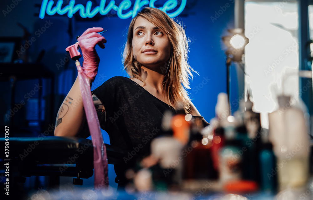 Modern tattoo studio with spotlight and neon lights and attractive ...