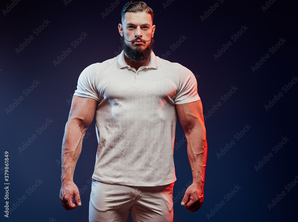 Foto de Handsome bodybuilder with black beard and mustache in white ...