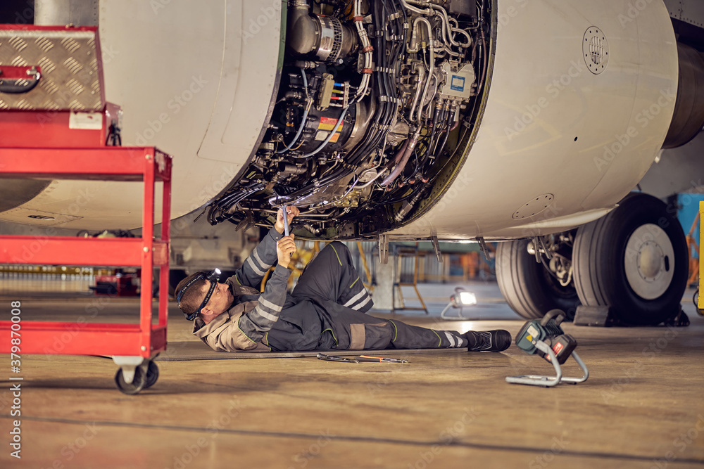 Ground crew working below a passenger airplane Stock Photo | Adobe Stock