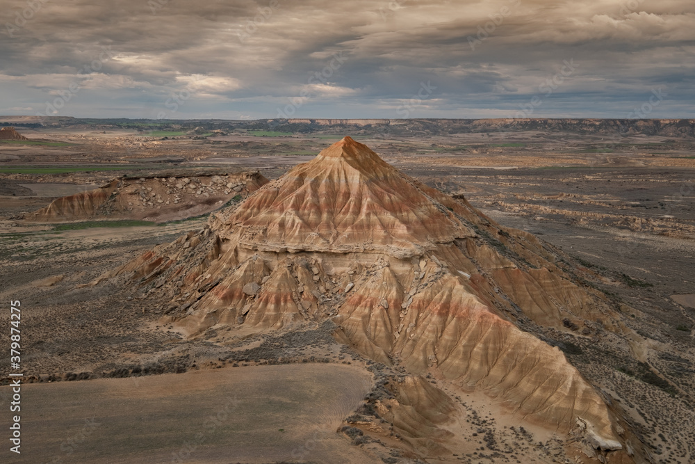 Landscape aerial view of an arid and isolated mountain in a cloudy ...