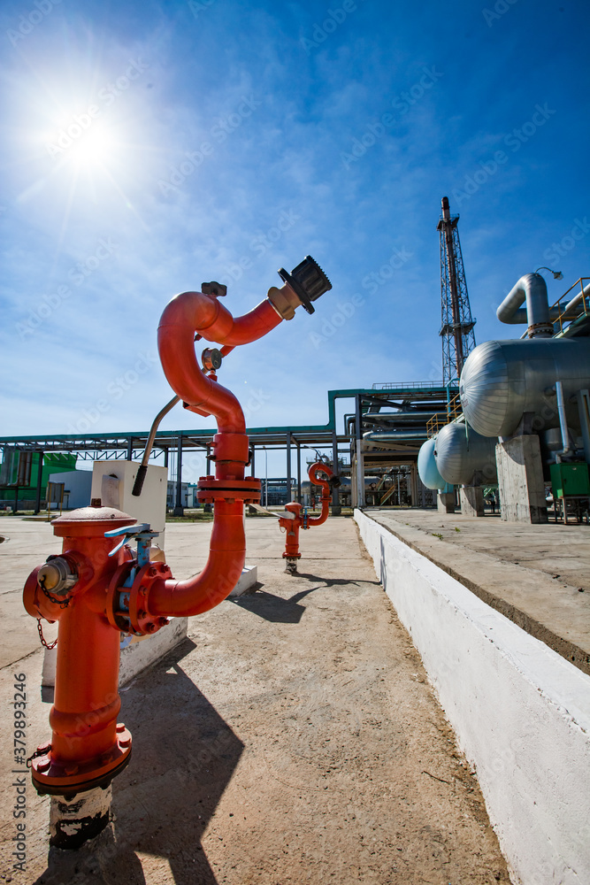 Petrochemical plant. (Oil refinery plant). Red fire extinguisher and ...
