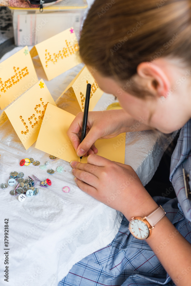 teen girl writing on hand made thank you cards Stock Photo | Adobe Stock