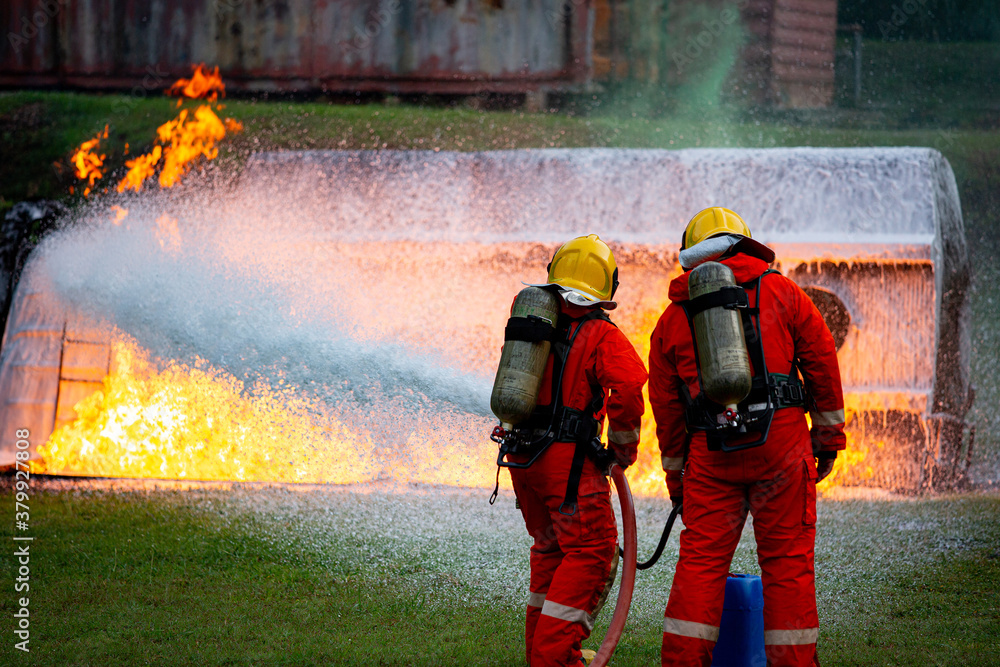 Firefighter on working by using using extinguisher water for put out ...