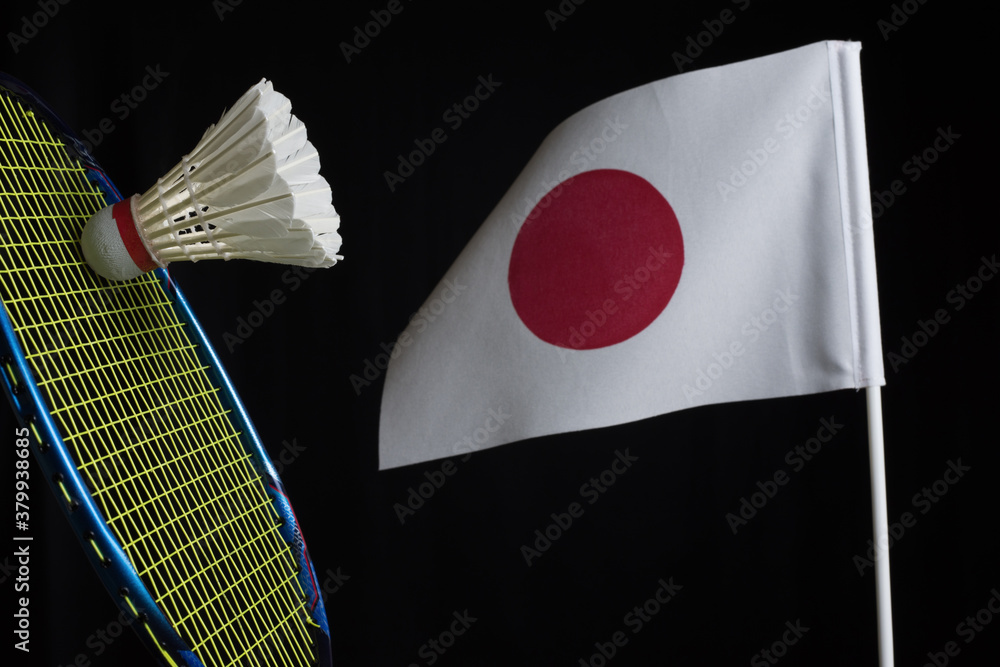 Badminton racket hitting shuttlecock and the flag of Japan fluttering ...
