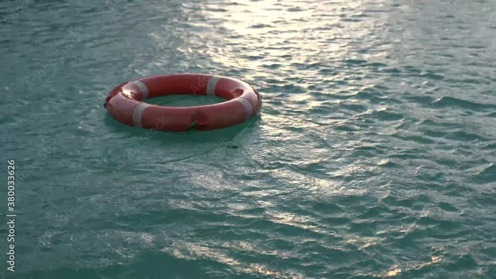 Lifebuoy Floating. Red life buoy over clear blue sea or ocean water ...