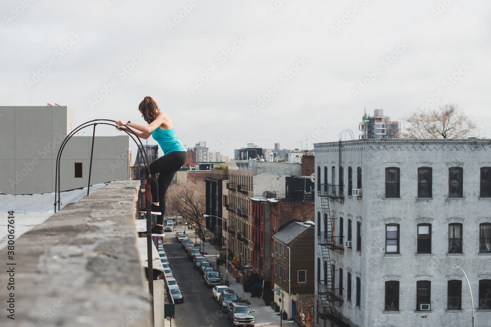 Athletic woman climbing ladder from roof Stock Photo | Adobe Stock