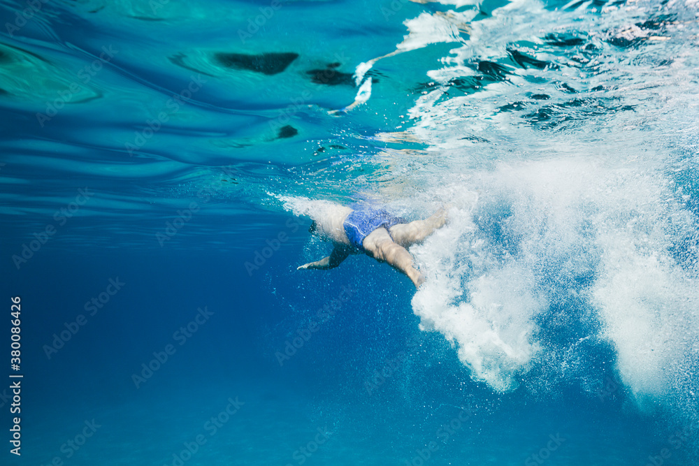 Underwater scene of a fit young man swimming in the sea Stock Photo ...