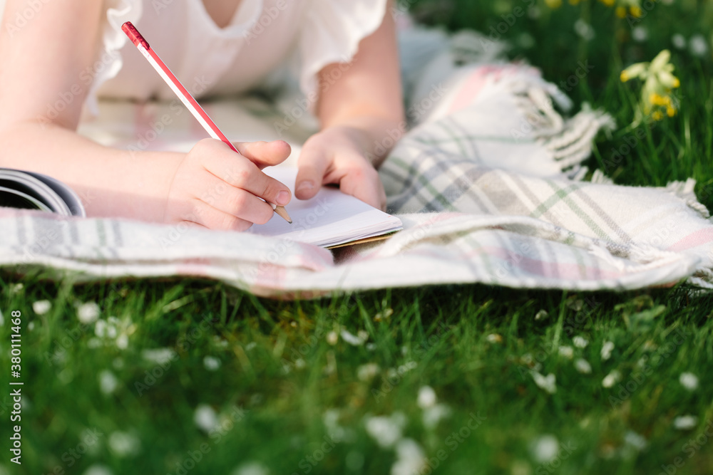 Tween girl drawing outdoors in early summer Stock Photo | Adobe Stock