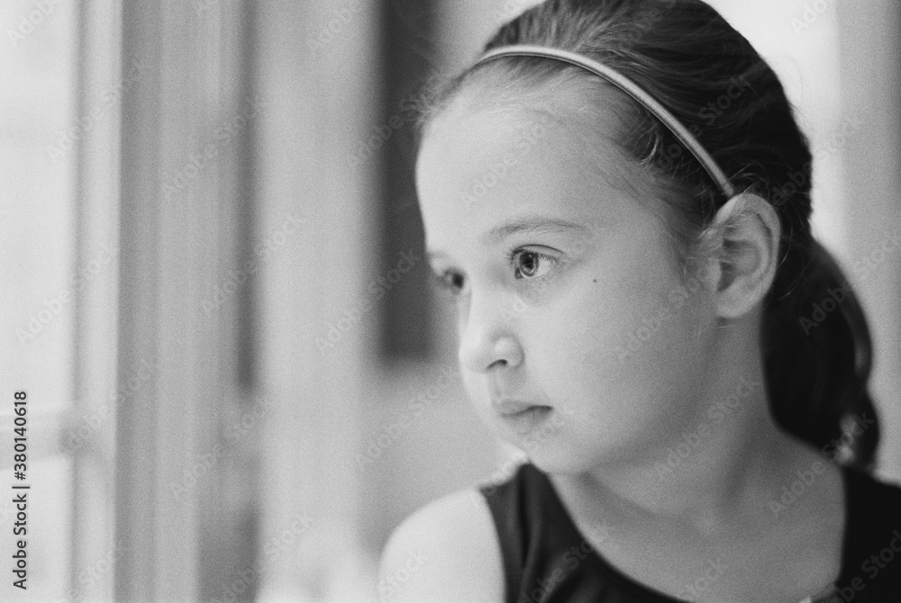 Beautiful young girl with big cheeks looking out a window Stock Photo ...