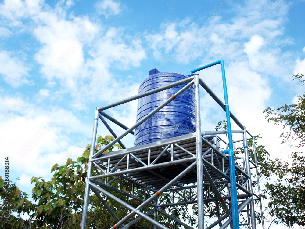 Metal structure of the blue water tank. Plastic buckets for water to be ...